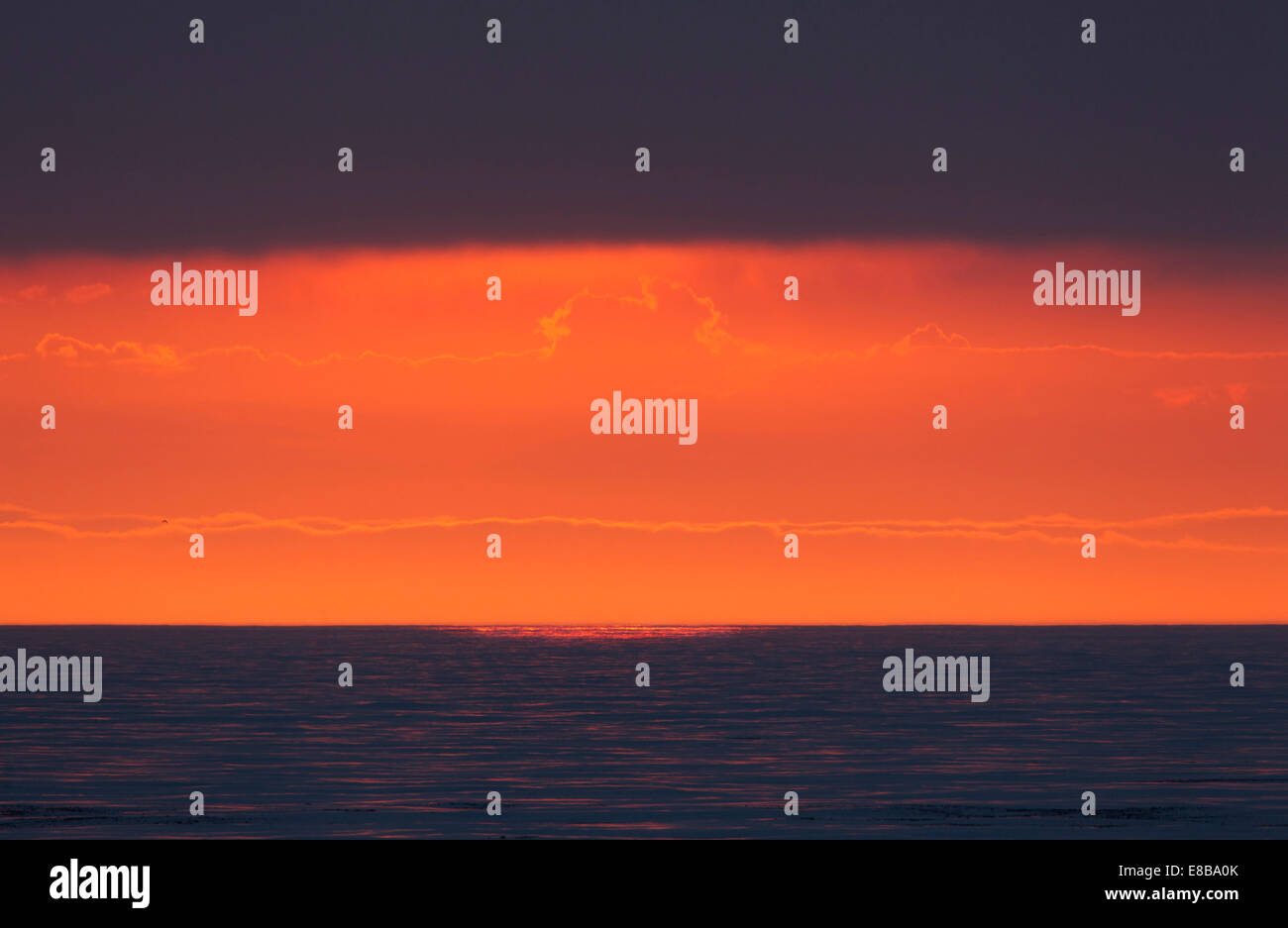 Orange Sky over Dark Ocean at Sunset Stock Photo - Alamy