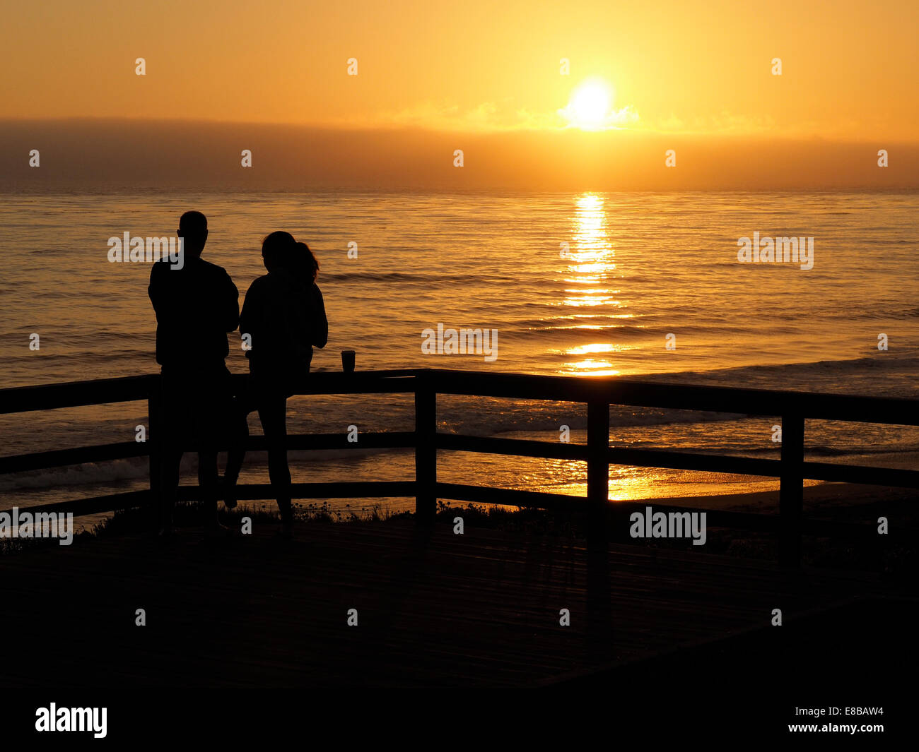 Man woman watching sunset over hi-res stock photography and images - Alamy