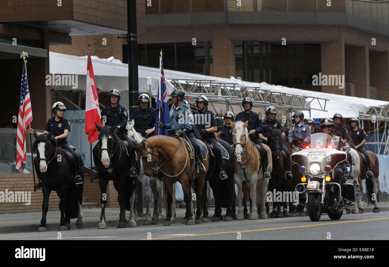 Vancouver, Canada. 3rd Oct, 2014. A police motorcyclist guides the ...