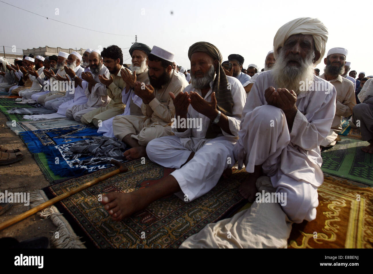Peshawar. 4th Oct, 2014. Afghan refugees pray during the Muslim festival of Eid Al-Adha in ...