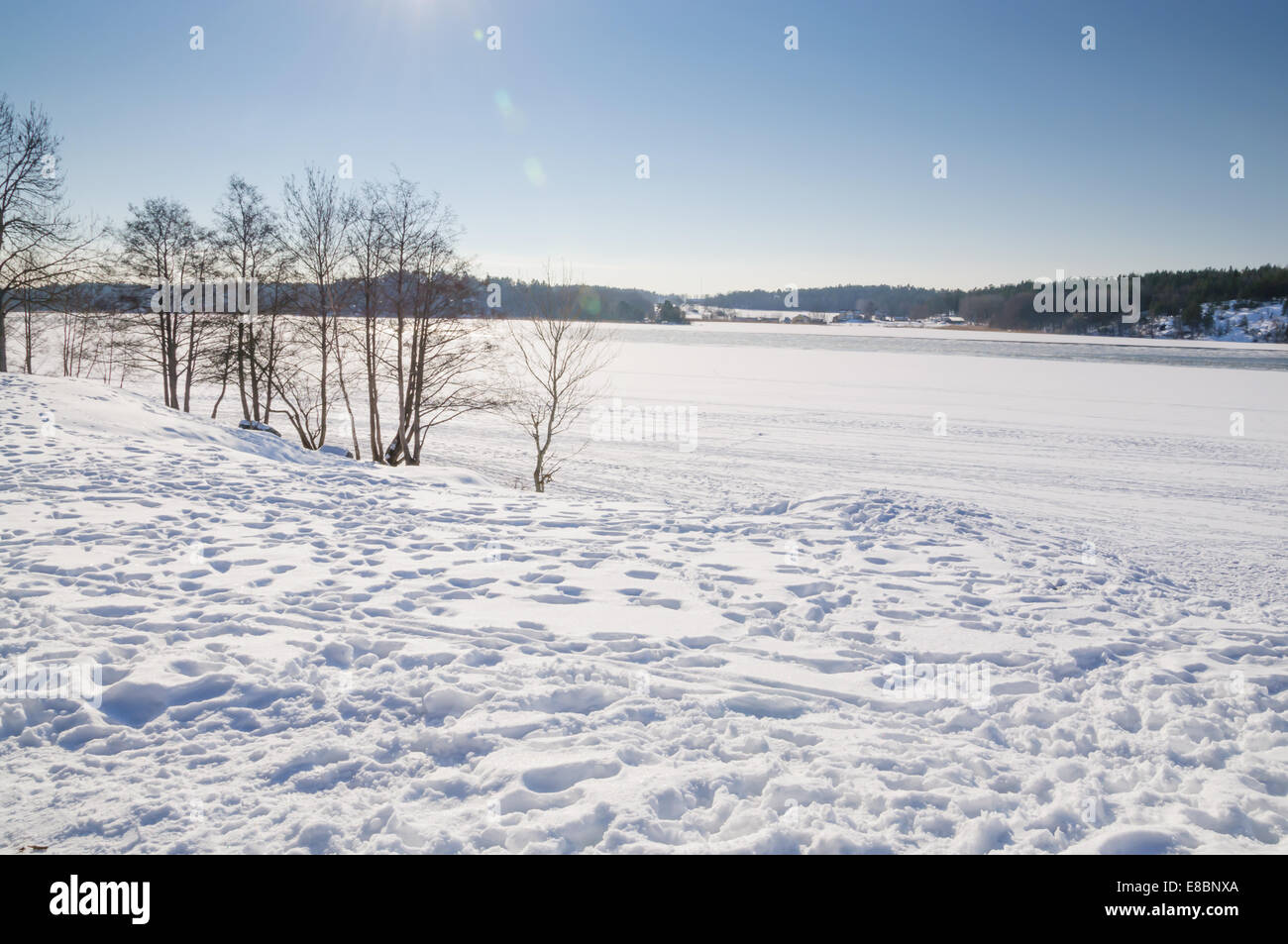 Snowy landscape by lake. Snow, ice and February sunshine by Lake ...
