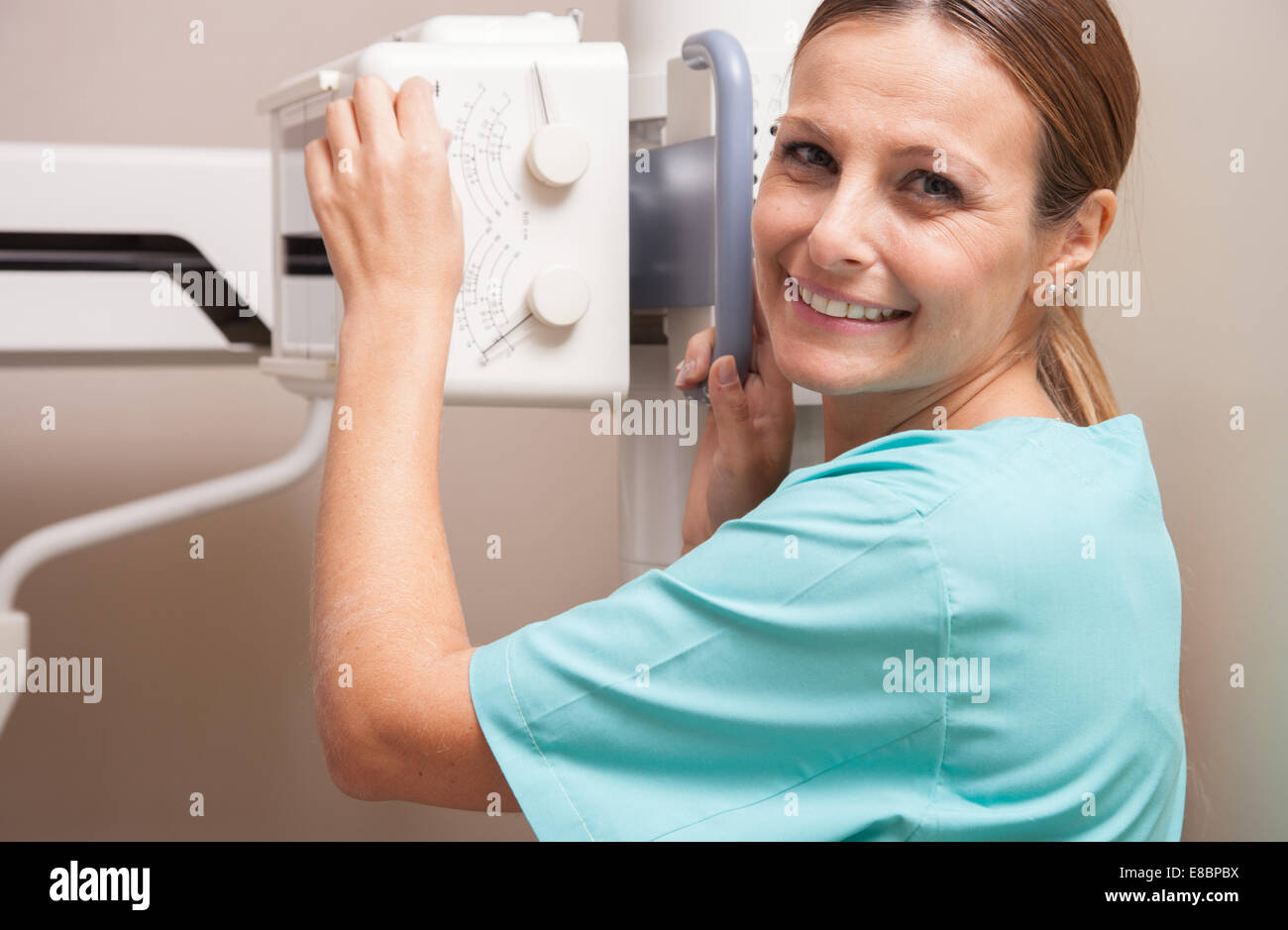 Female doctor setting up medical machine Stock Photo - Alamy