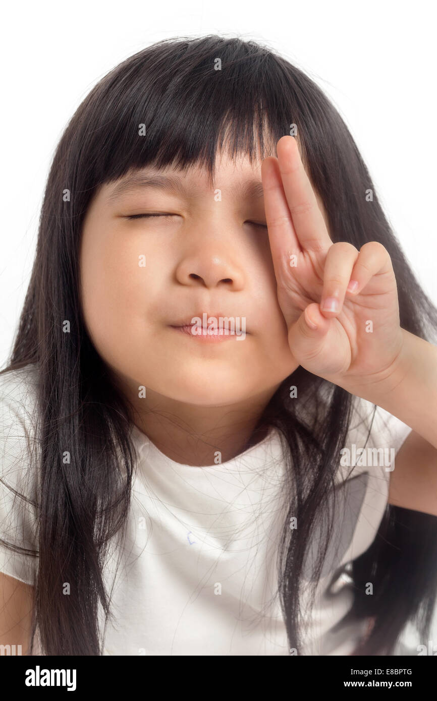 Child with two fingers on face and eye closing Stock Photo - Alamy