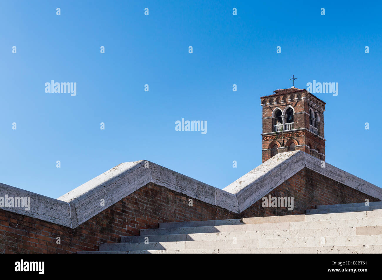 Church tower that rises behind a bridge in Venice, Italy Stock Photo ...
