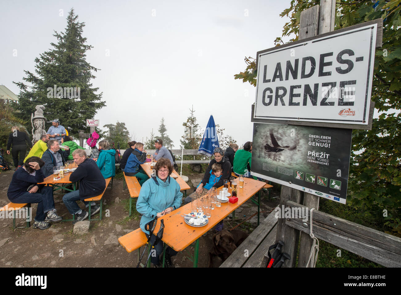 Hikers sit in the Osser-Schutzhaus Biergarten near the border in Lam ...