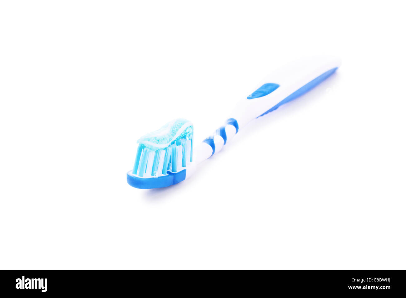 Close-up shot of a toothpaste on a blue toothbrush, isolated on white ...