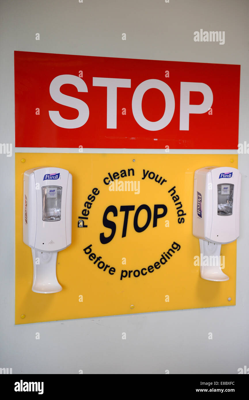 Stop clean your hands sign and dispensers at entrance to a hospital. UK ...