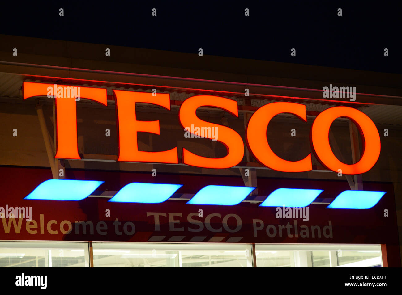 Tesco store sign at night, uk Stock Photo - Alamy