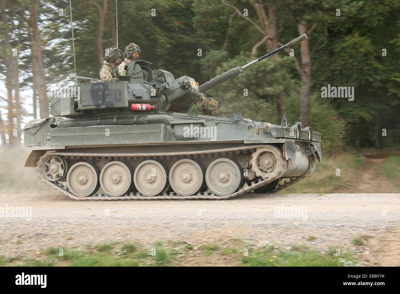 Scimitar armoured fighting vehicle moves at speed over rough terrain ...