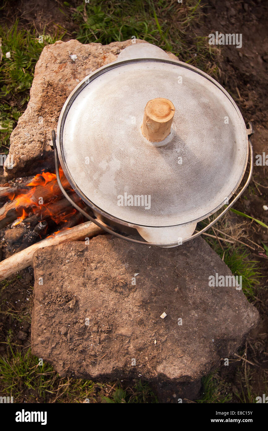 Cooking the meal in a kettle on the camp fire:River rafting expedition ...