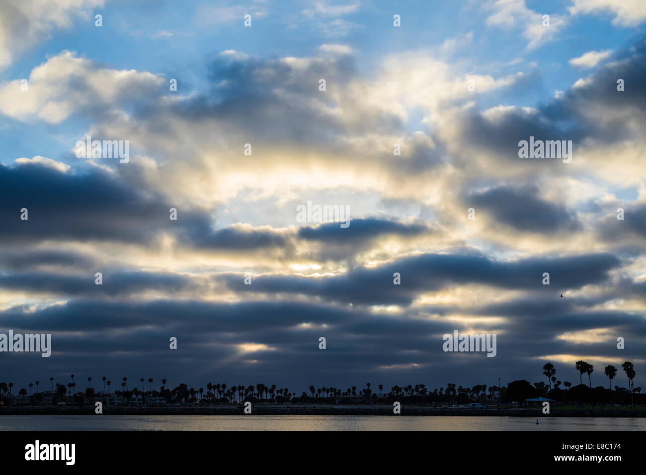 The setting Sun illuminating clouds viewed from Mission Bay Park. San ...