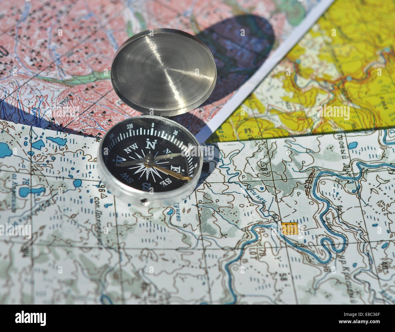 Compass, map. The magnetic compass is located on a topographic map ...