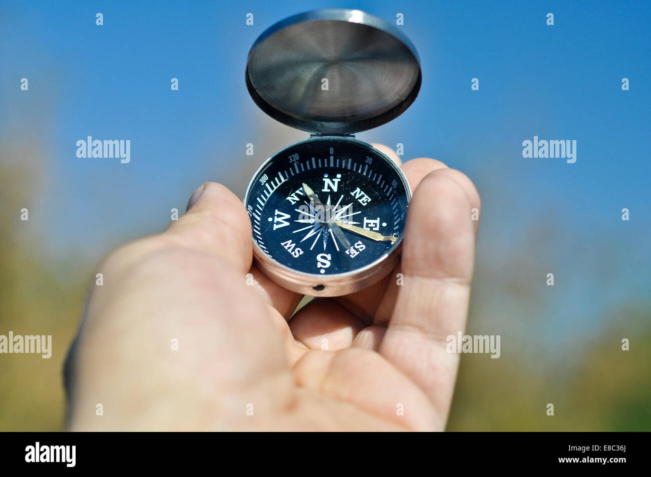 Compass in hand. Open the magnetic compass holds the left hand men ...