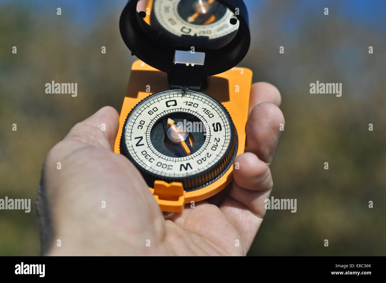 Compass in hand. Open the magnetic compass holds the left hand men ...