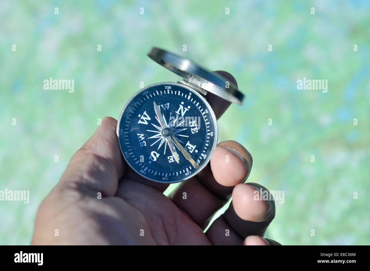 Compass in hand. Open the magnetic compass holds the left hand men ...