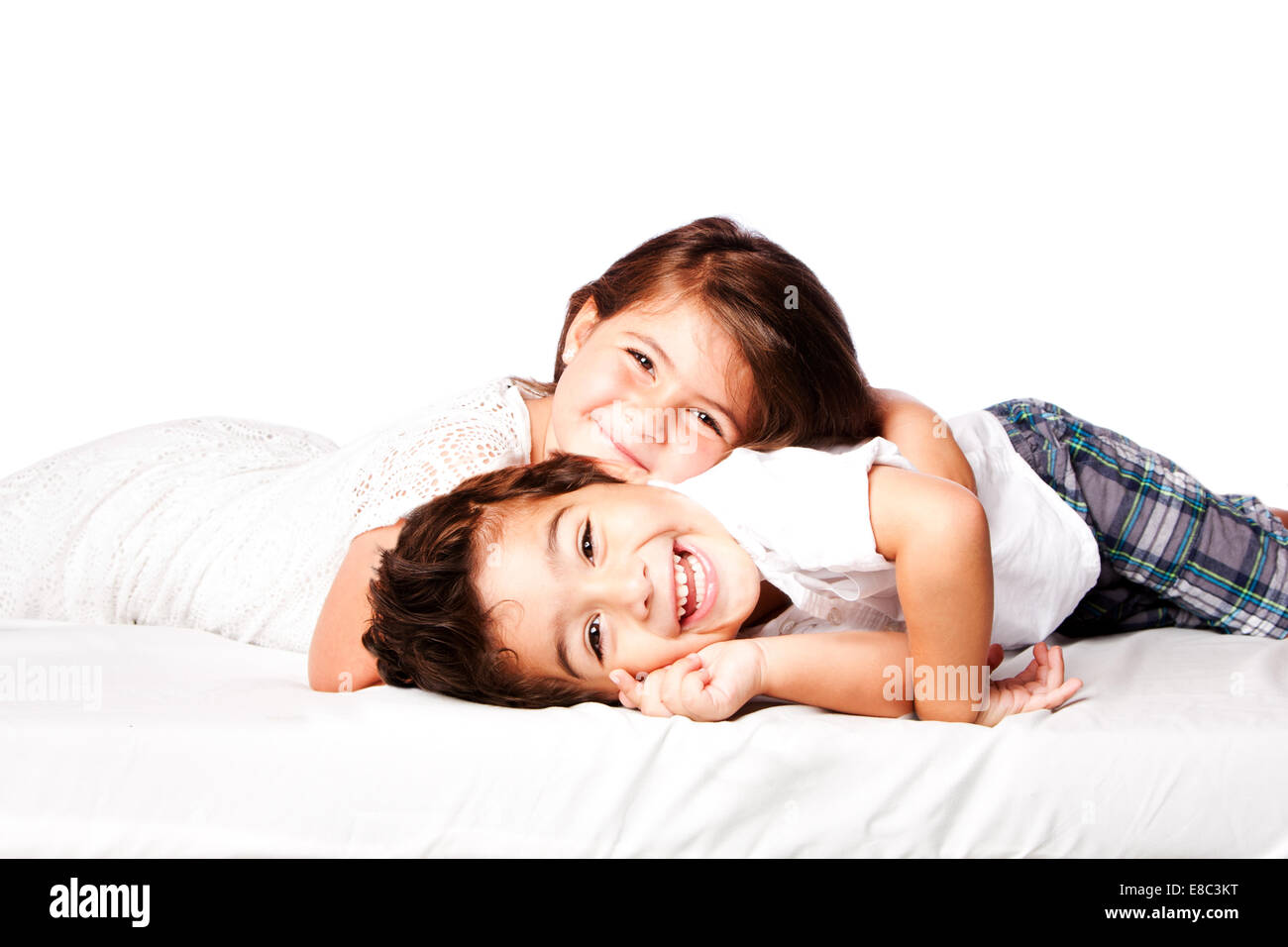 Happy smiling siblings brother sister together laying Stock Photo - Alamy