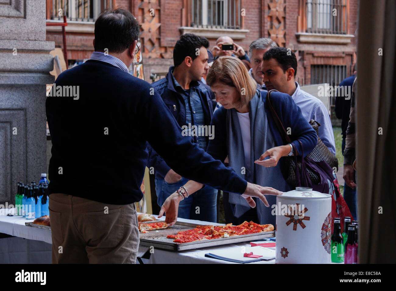 The people are busy taste bread during the " Una Mole di pane". The ...