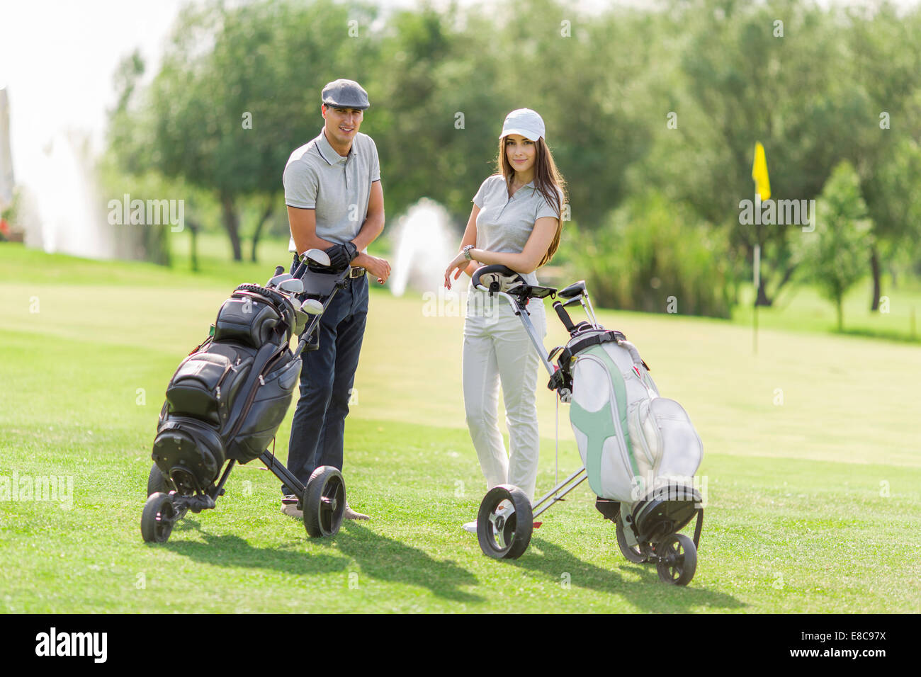 Young couple playing golf Stock Photo - Alamy
