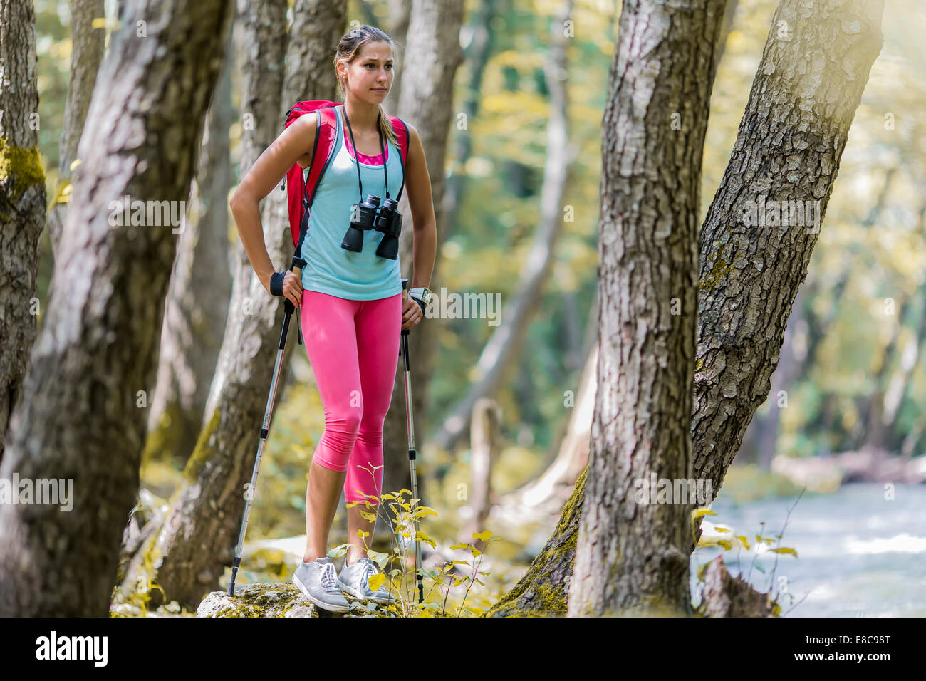 Young woman hiking in the forest Stock Photo - Alamy
