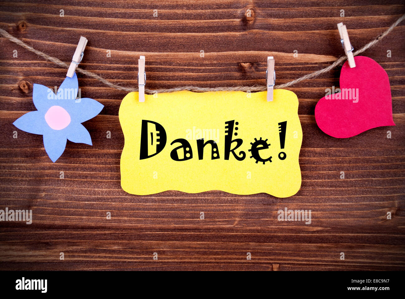Happy looking german Danke, which means Thank You, on a Yellow Label ...