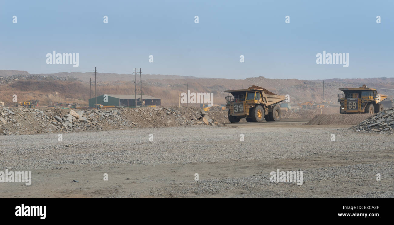 Two mining dump trucks transport copper ore from an open cast mine to ...