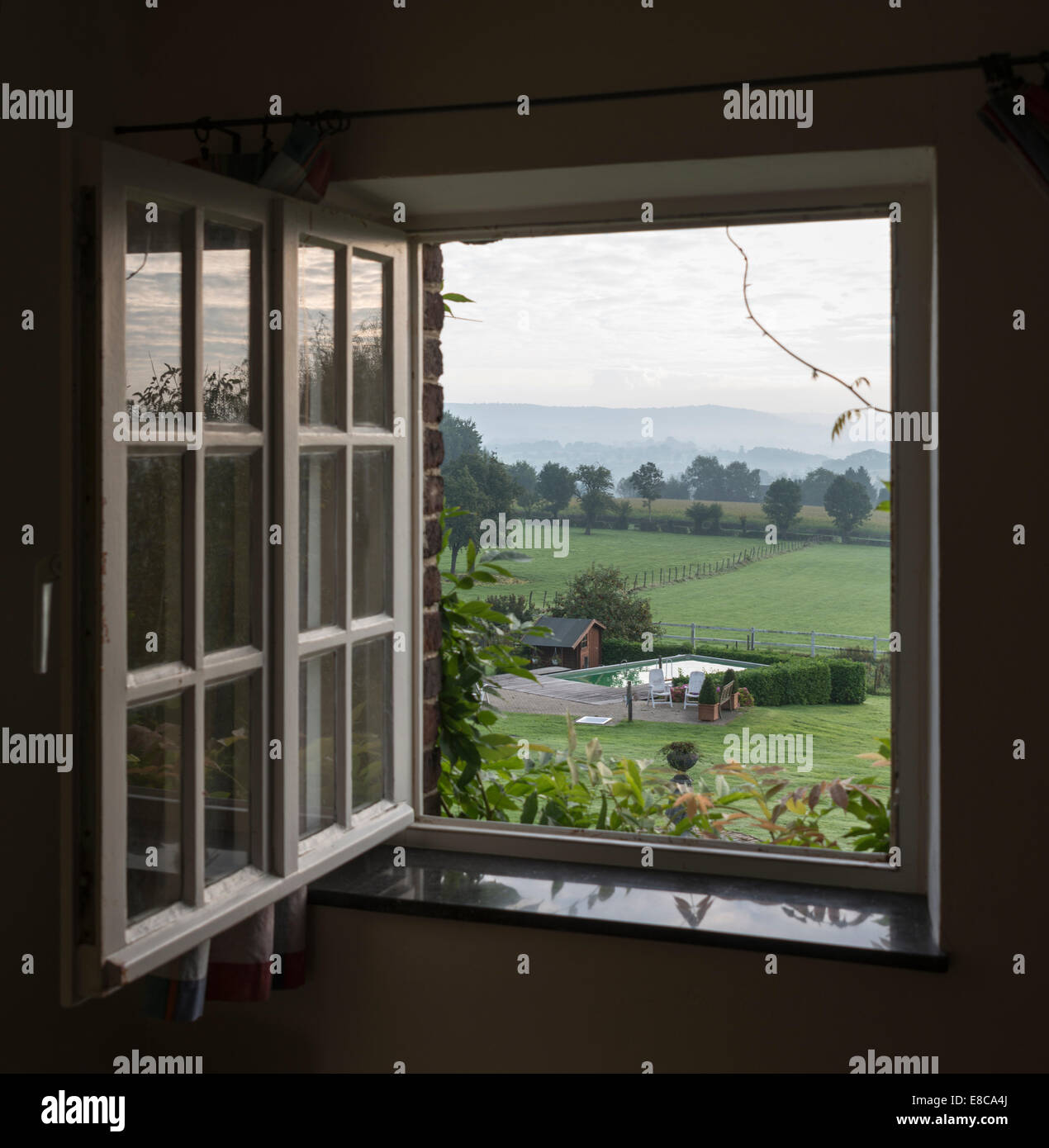 see through window with landscape and hills of belgium as background ...