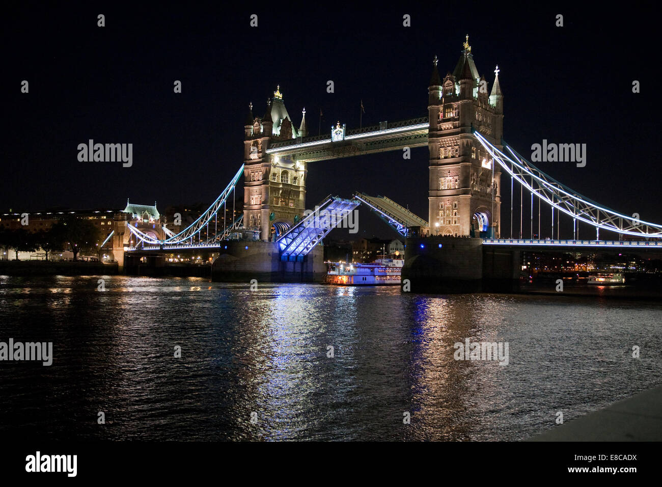 Tower Bridge in London lifts up early evening in Autumn to allow the ...