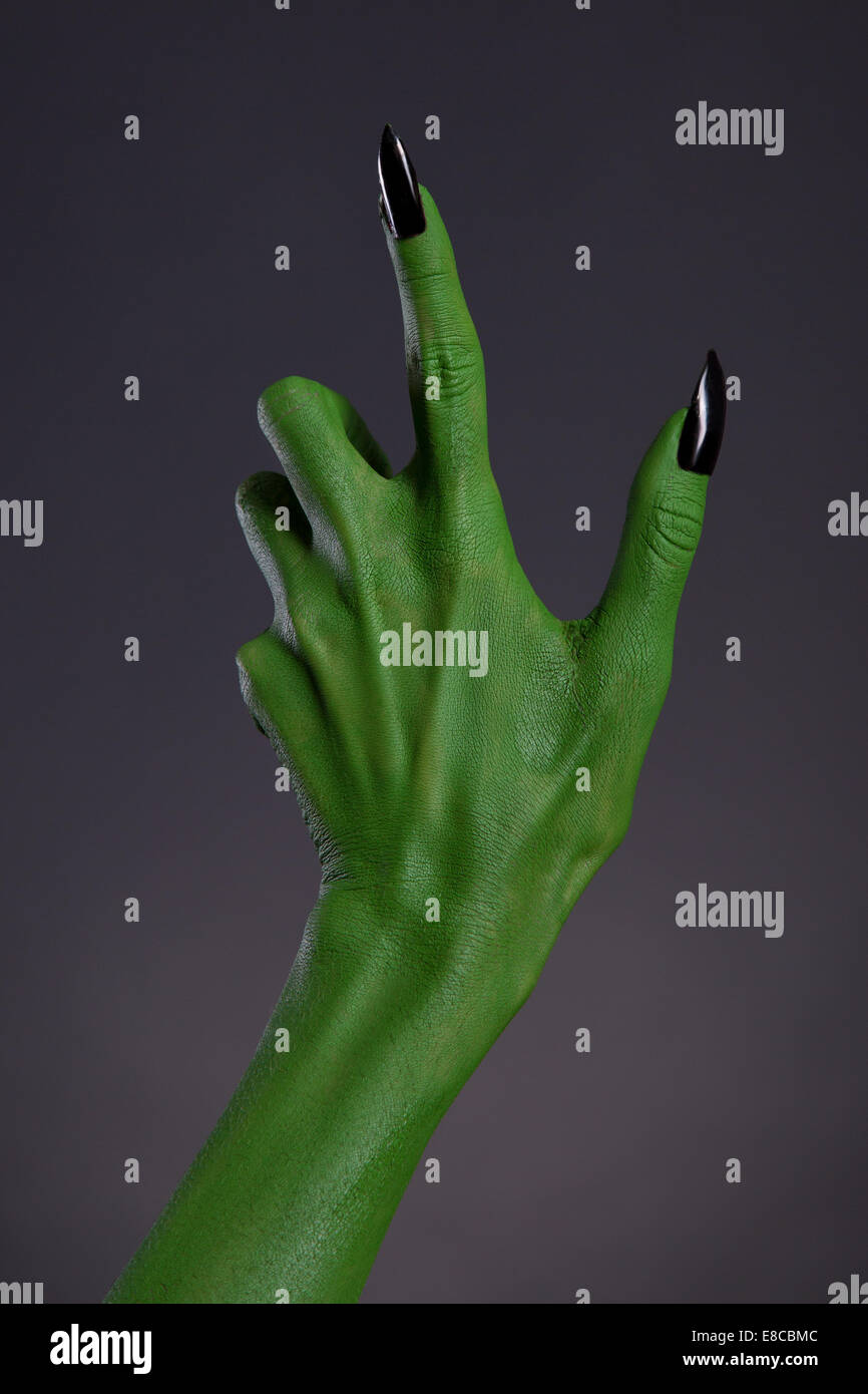 Green witch hand with black nails, Halloween theme, studio shot on ...