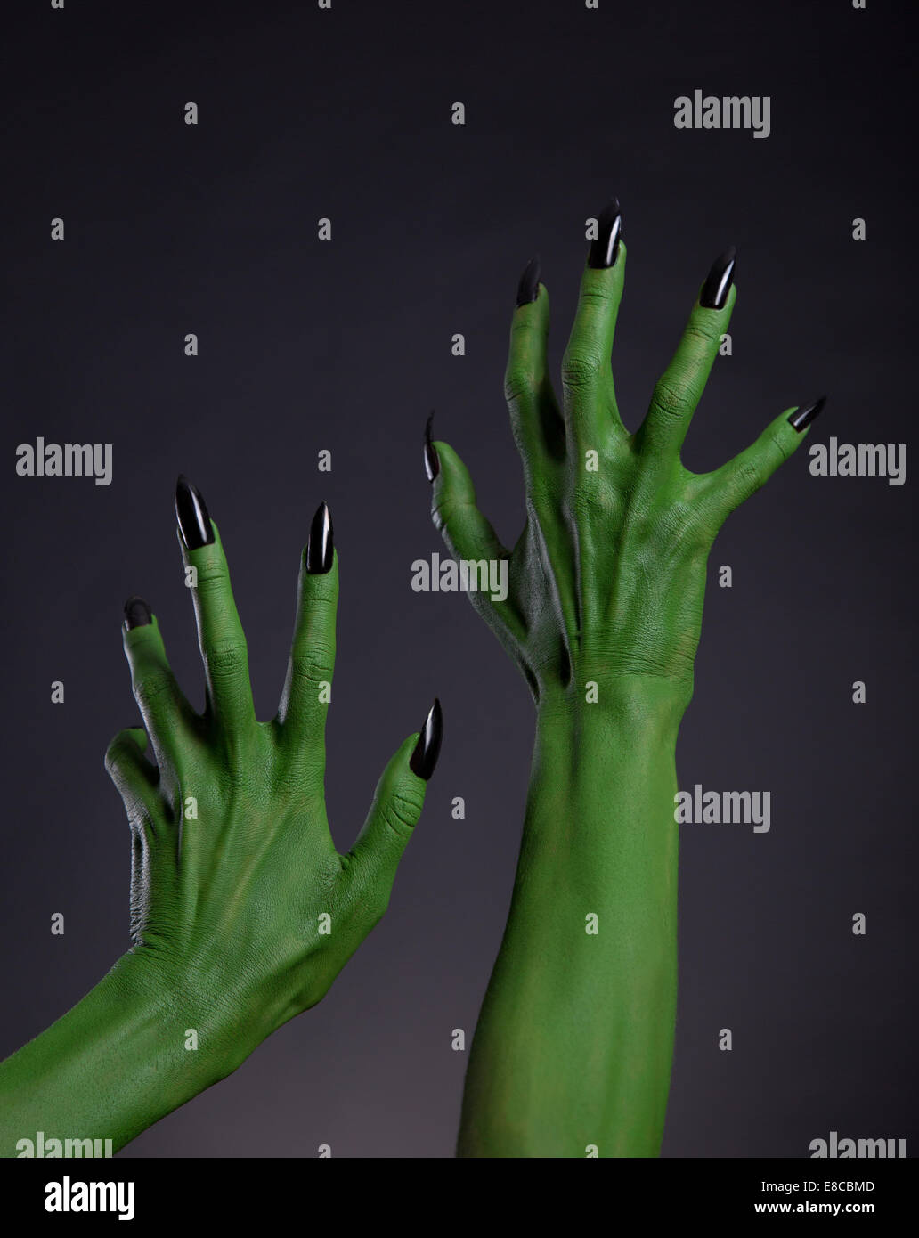 Green witch hands with black nails stretching up, Halloween theme ...