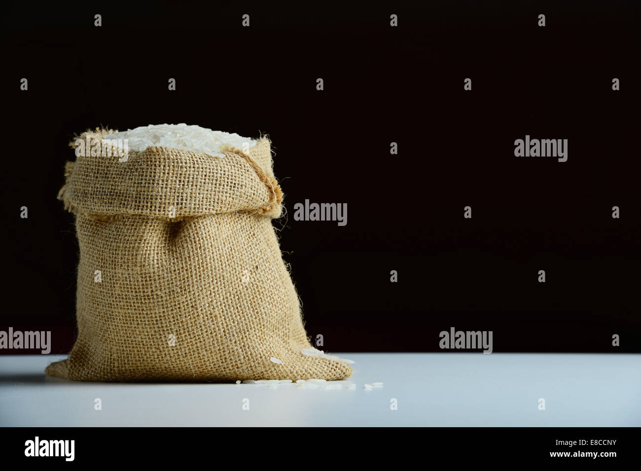 white rice in burlap sack Stock Photo - Alamy