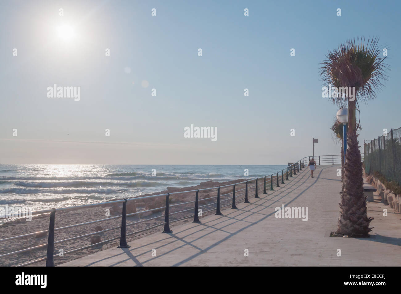 Sea promenade scene on a windy day with scirocco winds, bringing red ...