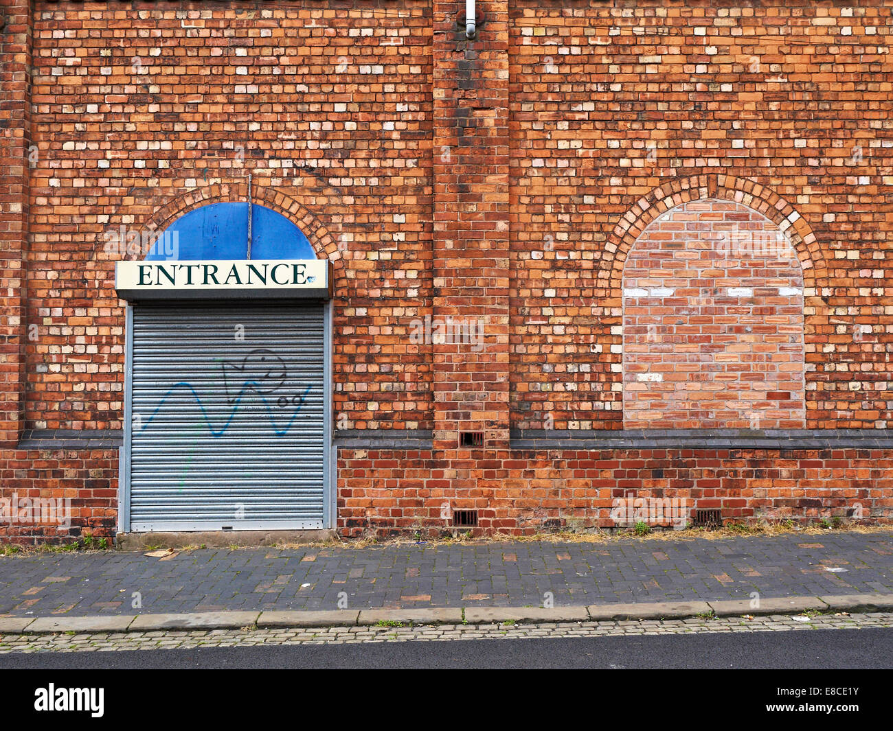 Bricked up window with closed entrance on factory building UK Stock ...