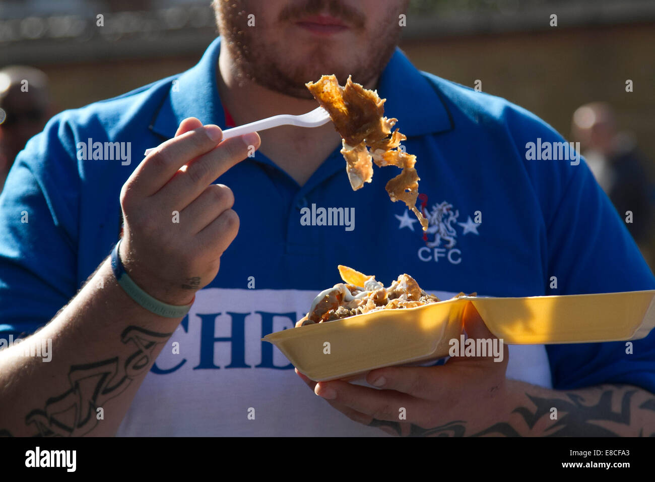 Stamford Bridge, London, UK. 5th Oct, 2014. A Chelsea supporter eating ...