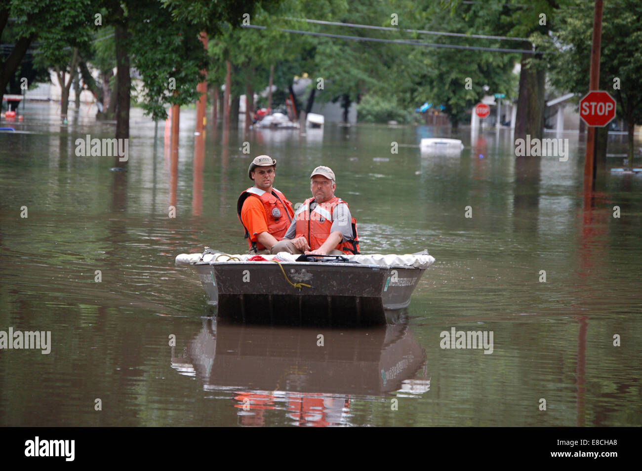 This photograph shows USGS employees conducting fieldwork in a boat ...