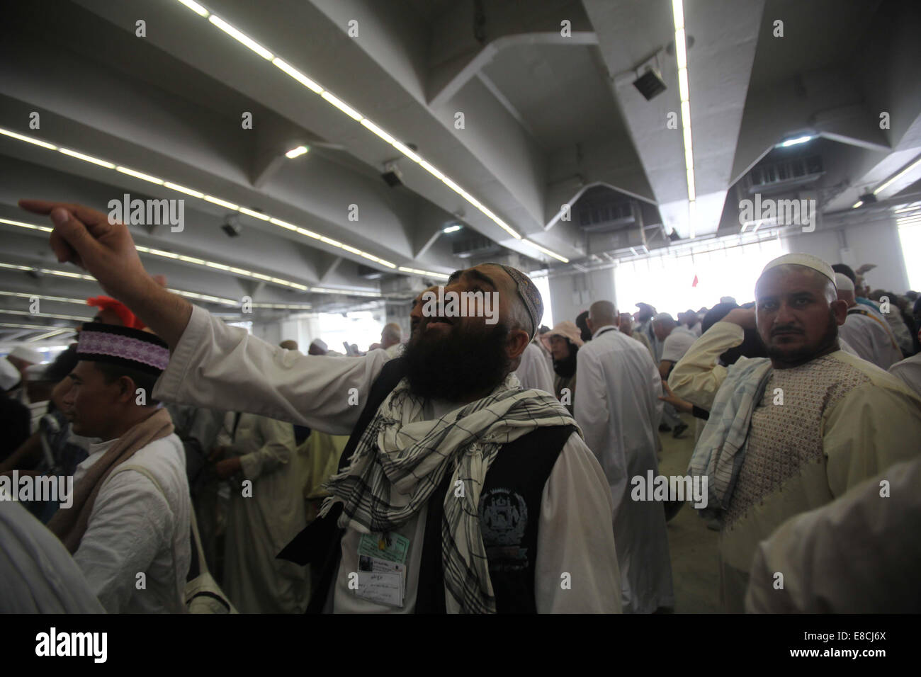 Mina, Mecca, Saudi Arabia. 5th Oct, 2014. Muslim pilgrims walk to cast ...