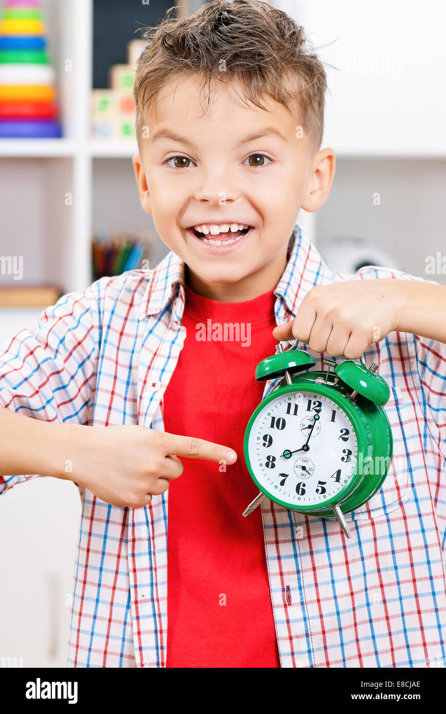 Boy with alarm clock Stock Photo - Alamy