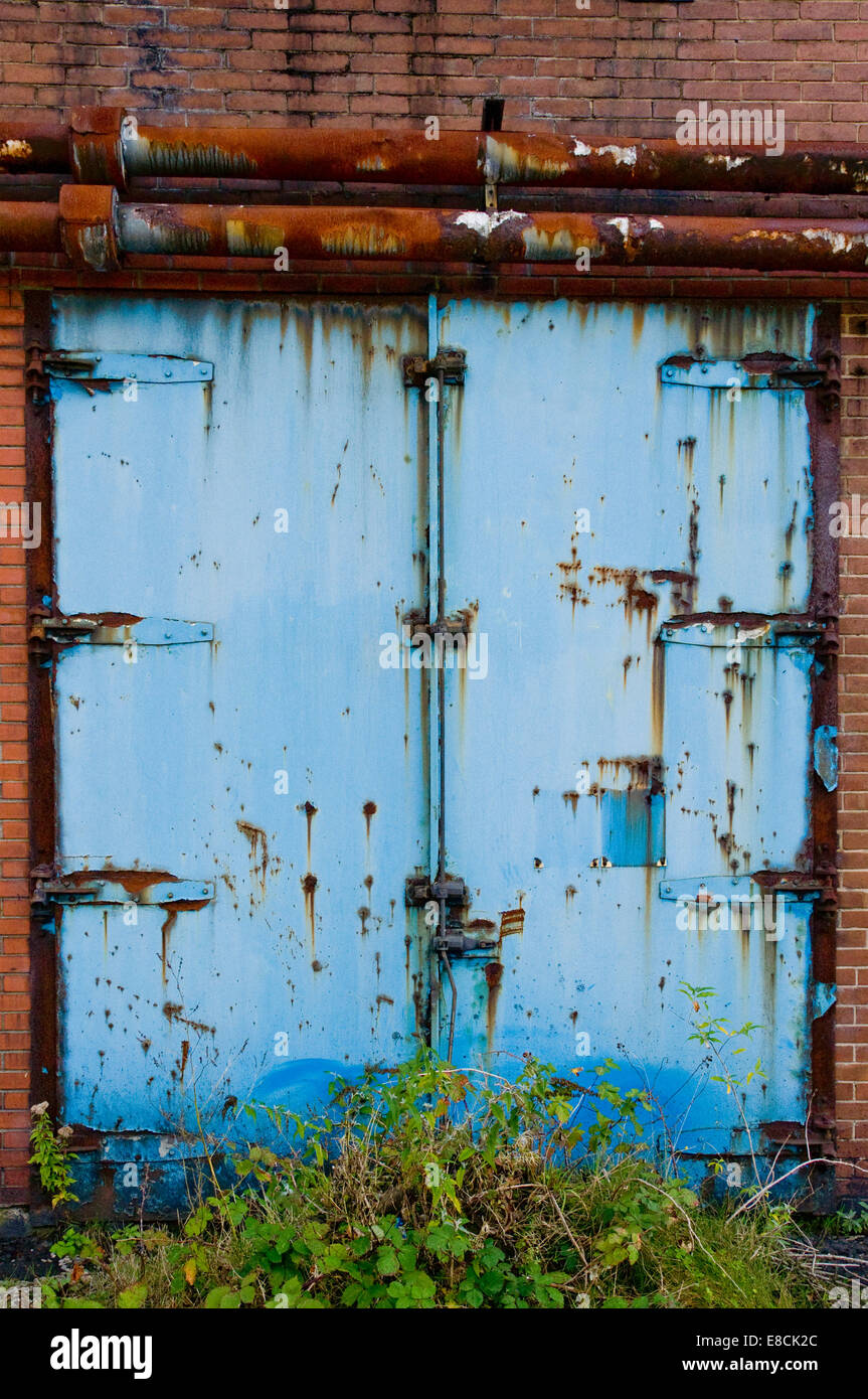 Blue rusting industrial metal doors Stock Photo - Alamy