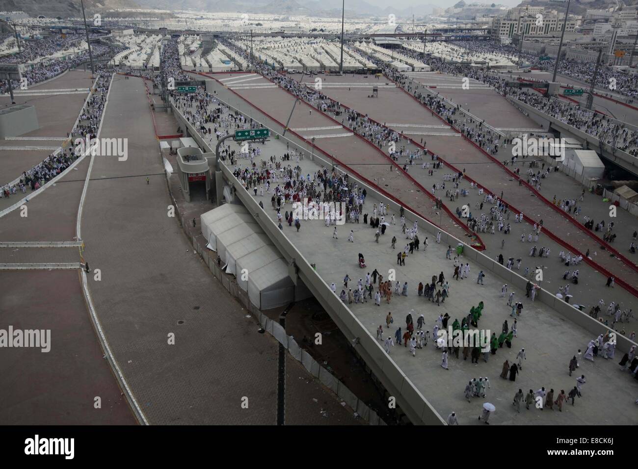 Mina, Mecca, Saudi Arabia. 5th Oct, 2014. Muslim pilgrims walk to cast ...