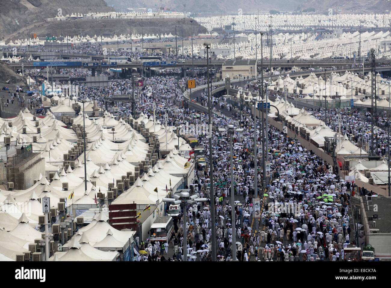 Mina, Mecca, Saudi Arabia. 5th Oct, 2014. Muslim pilgrims walk to cast ...