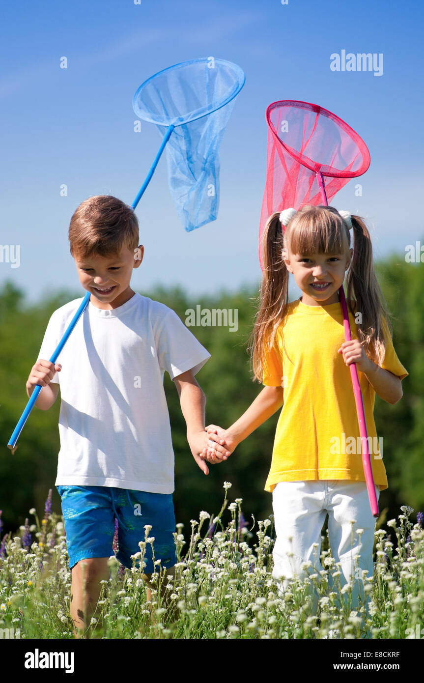 Happy children on meadow Stock Photo - Alamy