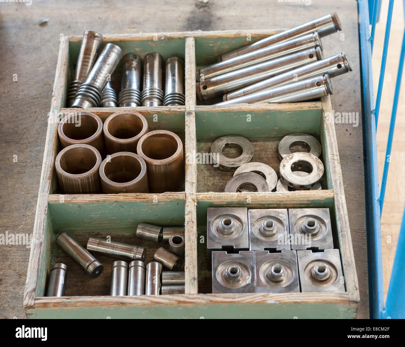 automotive industry spare parts (steel shafts and bolts) in a wooden ...