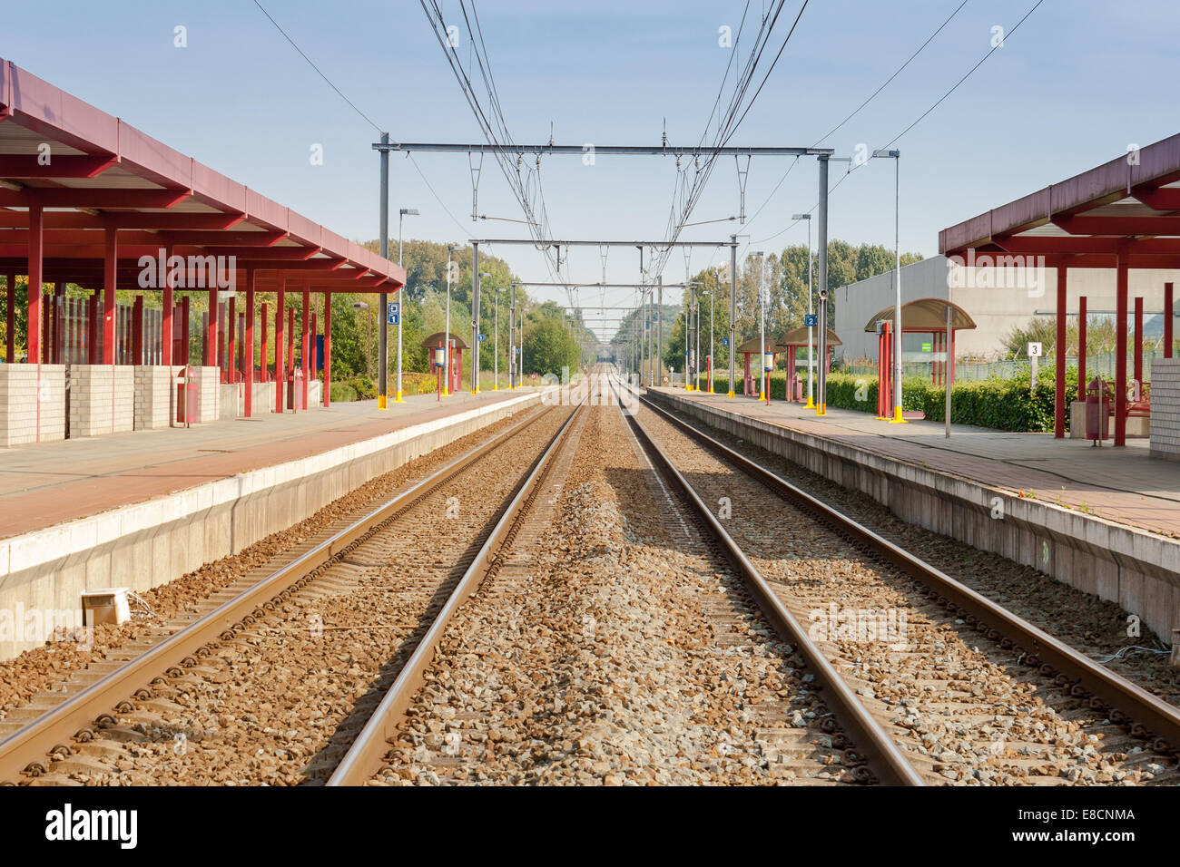railway station with two tracks and electric power Stock Photo - Alamy