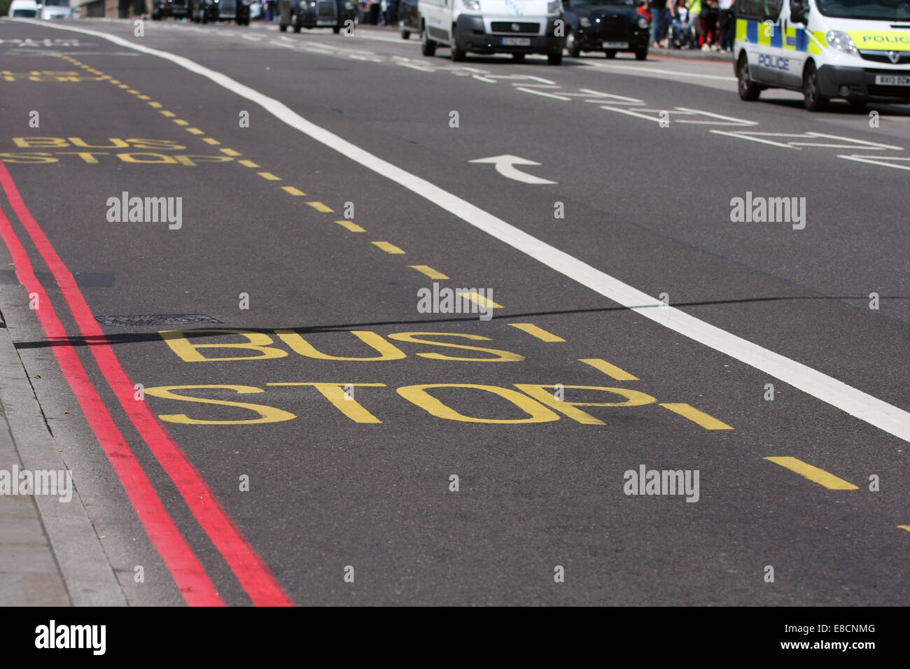 A view of a bus lane and bus stop signs on Westminster Bridge in London ...