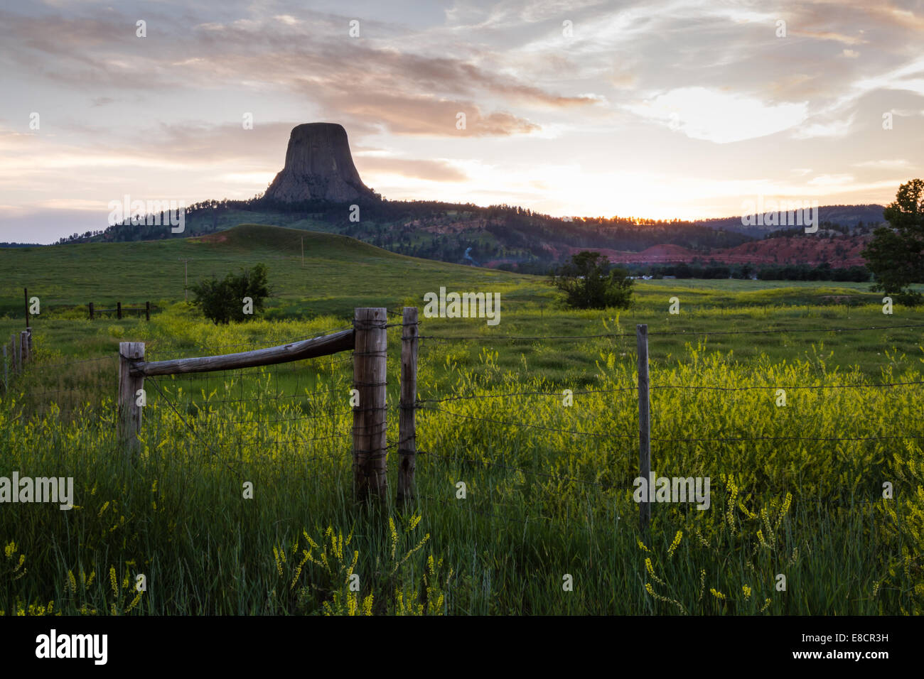 sunset including a farm and Devils Tower National monument , old west ...