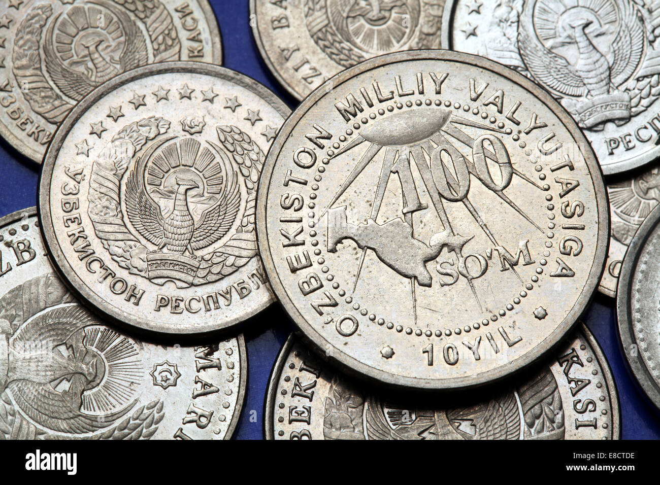 Coins of Uzbekistan. State emblem of Uzbekistan and a map of Uzbekistan ...