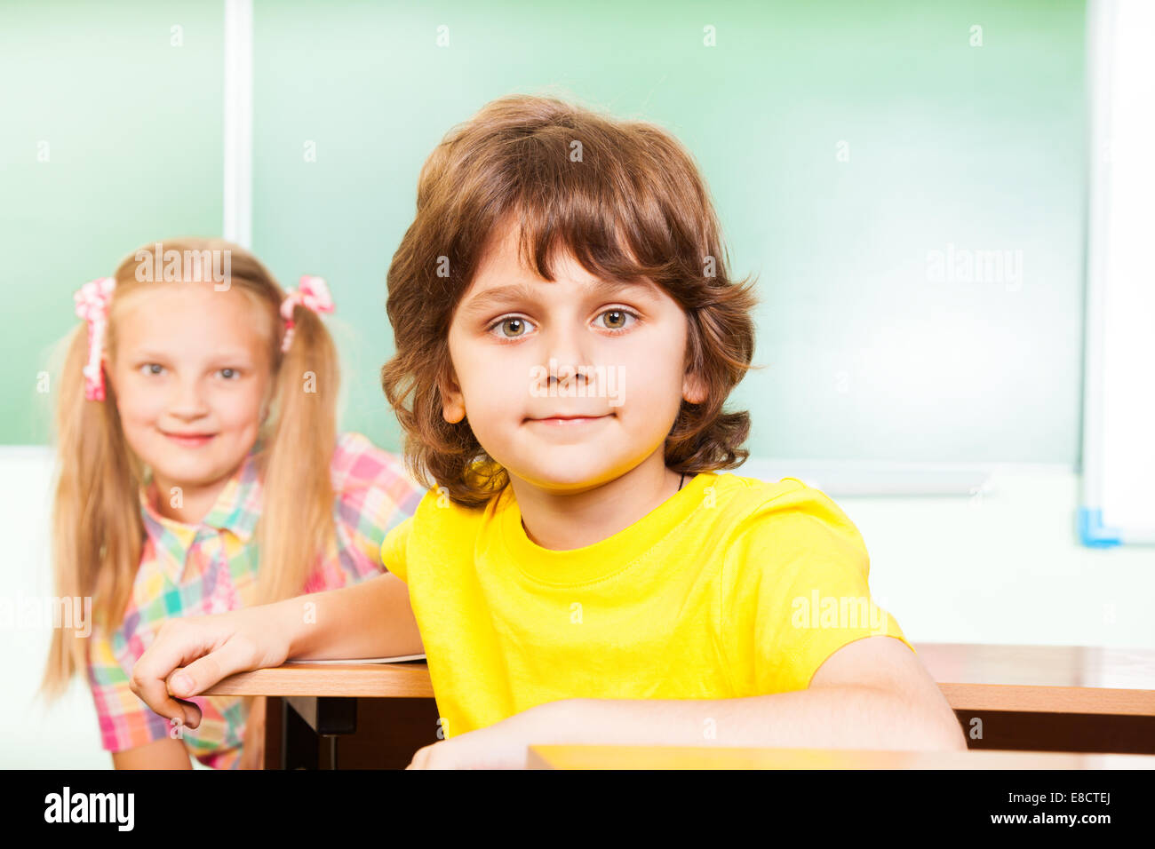 Children sitting at their school desks hi-res stock photography and ...