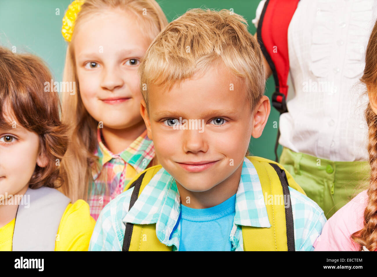Happy children stand together near blackboard Stock Photo - Alamy