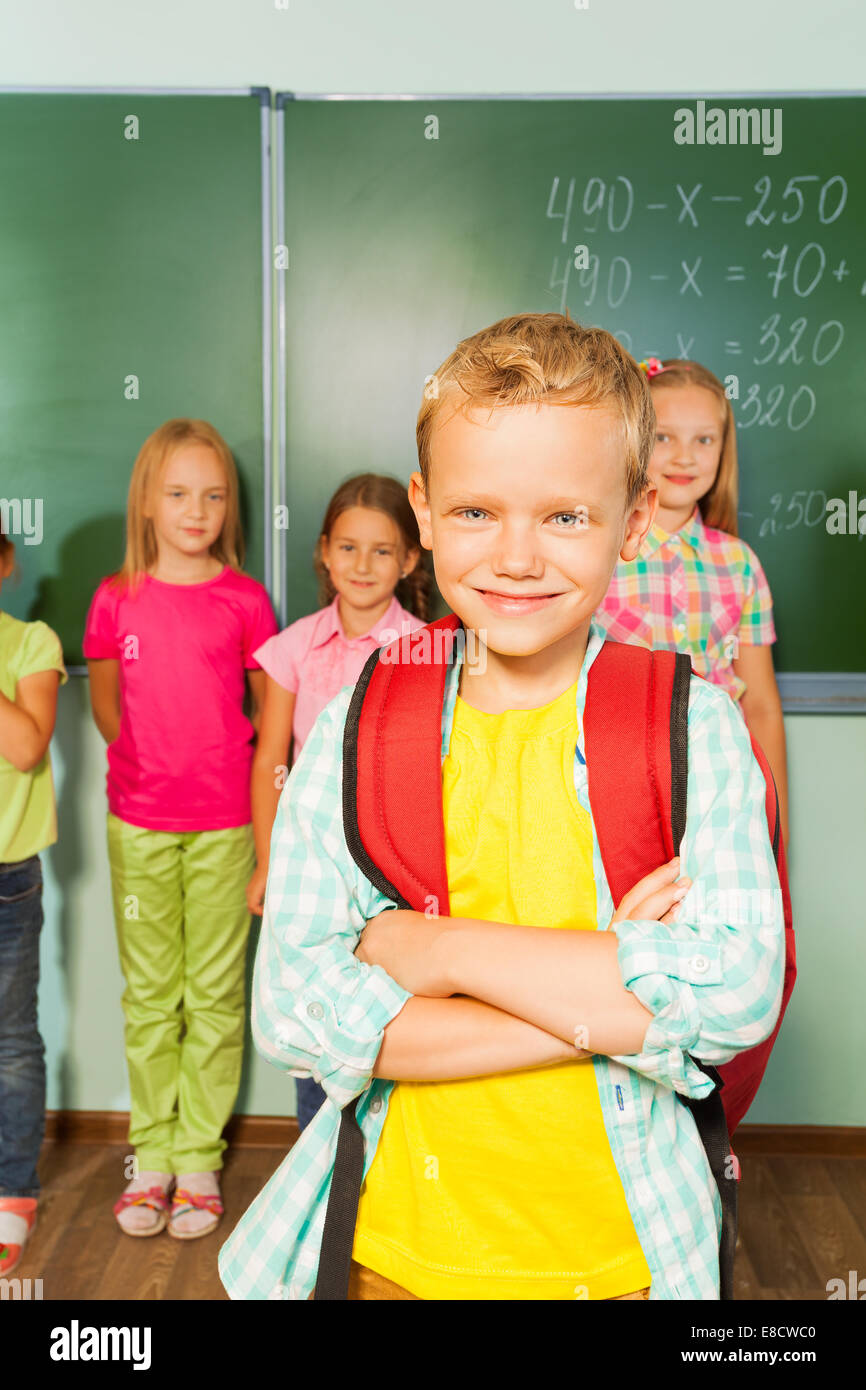 Boy stands in front of kids near blackboard Stock Photo - Alamy