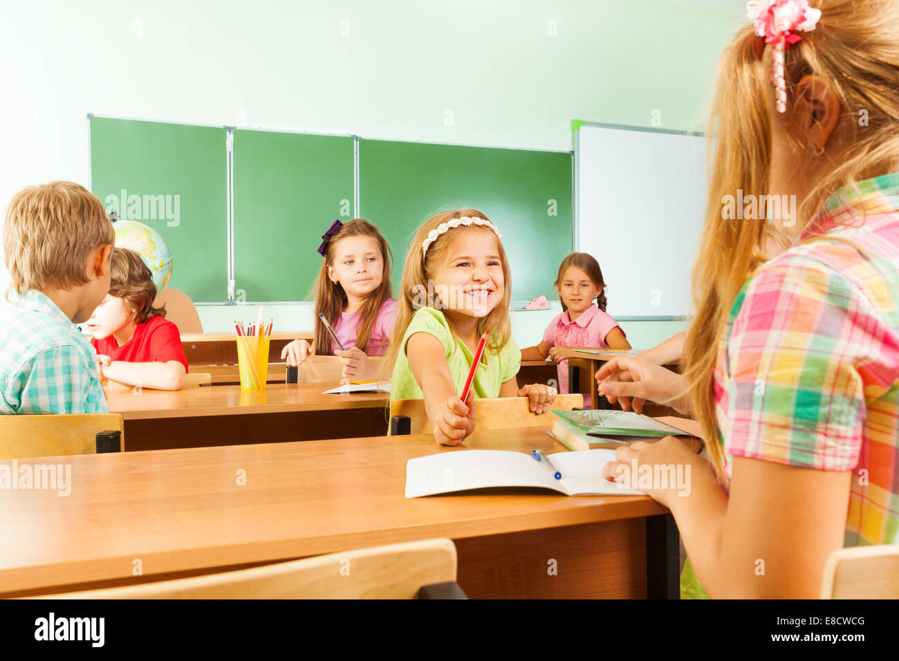 Children sitting desks in classroom hi-res stock photography and images ...