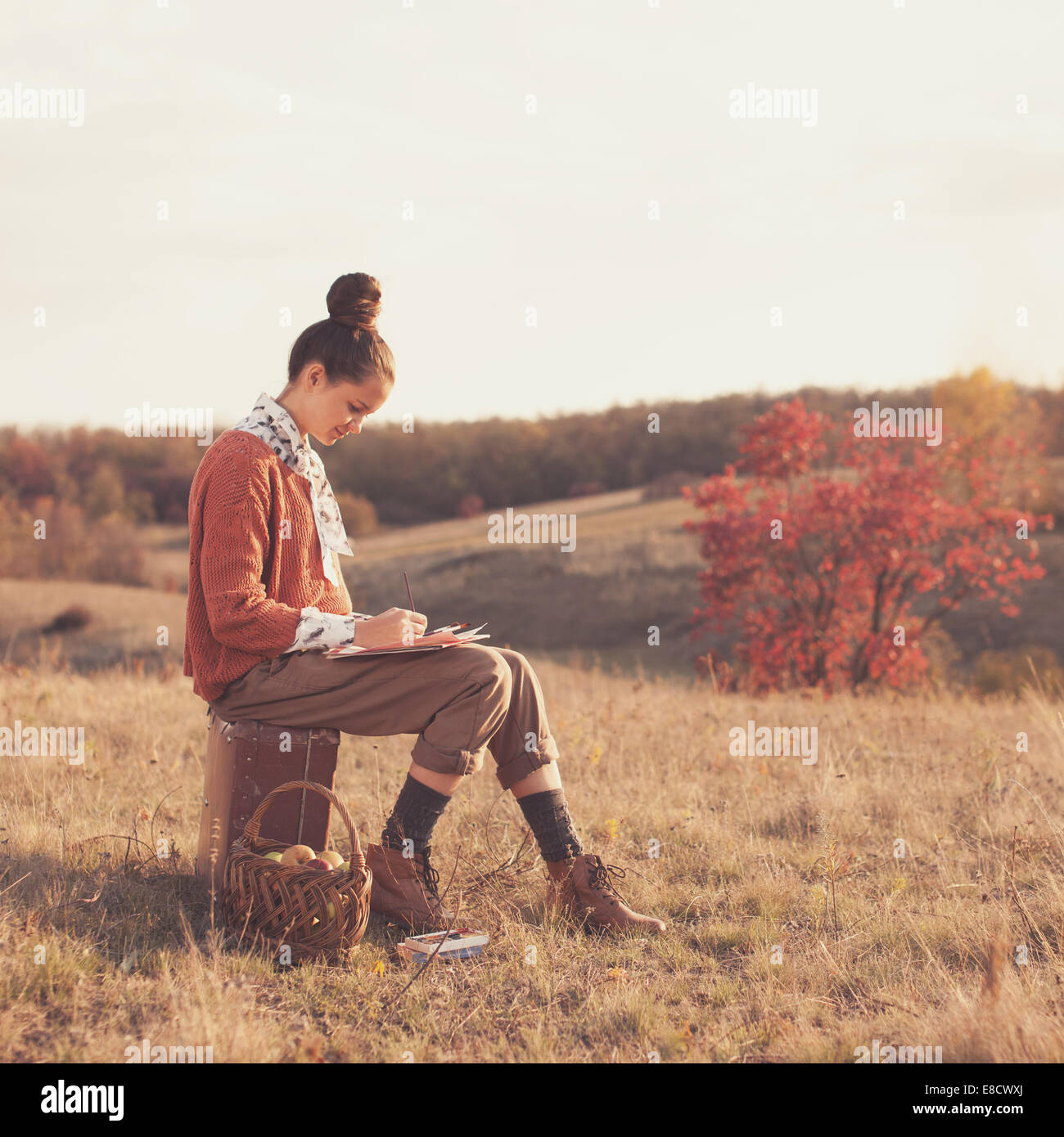 Hipster girl drawing in the fall outdoors Stock Photo - Alamy